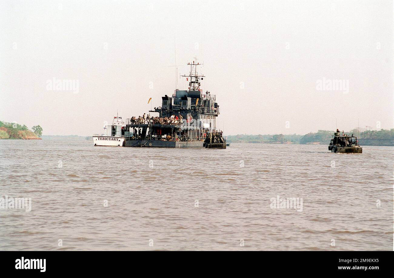 Riverine Assult Crafts perform a security circle around the C-05 ITIAPU ...