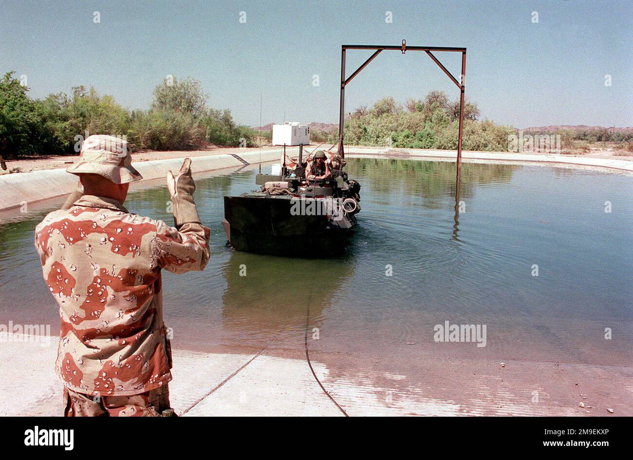 A rear view, medium shot over the shoulder of a US Marine from 1ST ...