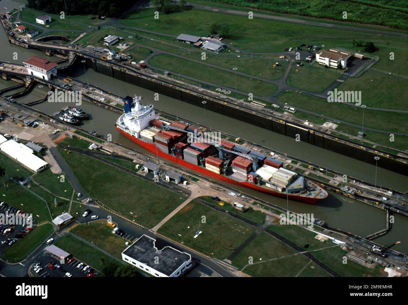 A container ship passes through the Panama Canal's Miraflores Locks ...