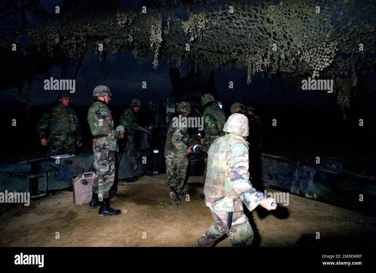 Rear view medium night time shot of a M198 155mm Howitzer as US Marines ...