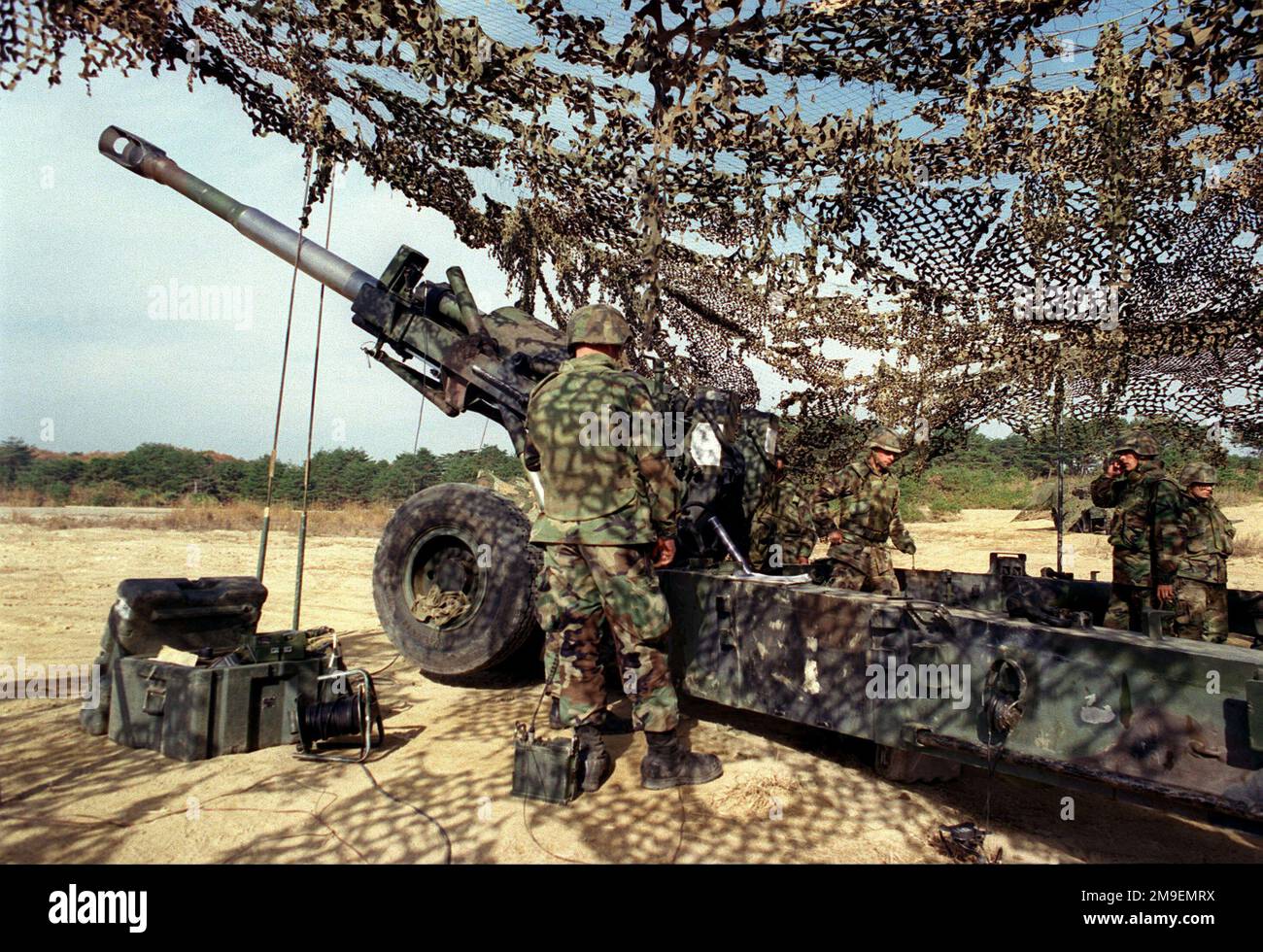 Left side rear view medium shot of a US Marine M198 155mm Howitzer as Marine Cannoneers from ...