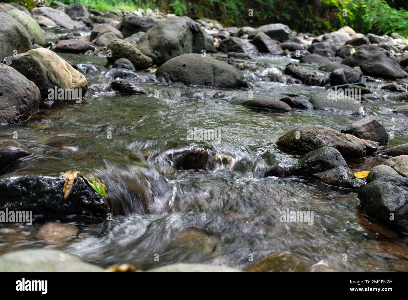 Water passing over river stones Stock Photo - Alamy