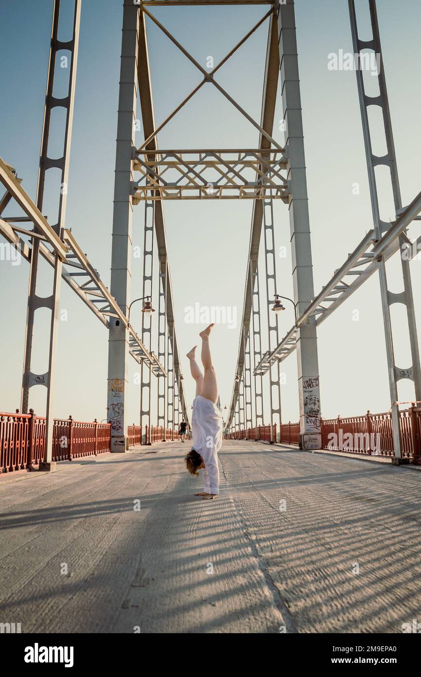 Handstand on pathway bridge scenic photography Stock Photo - Alamy