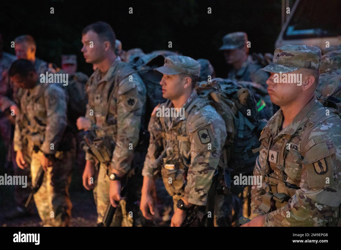 Army National Guard Soldiers get ready to start a 12 mile ruck march, a ...
