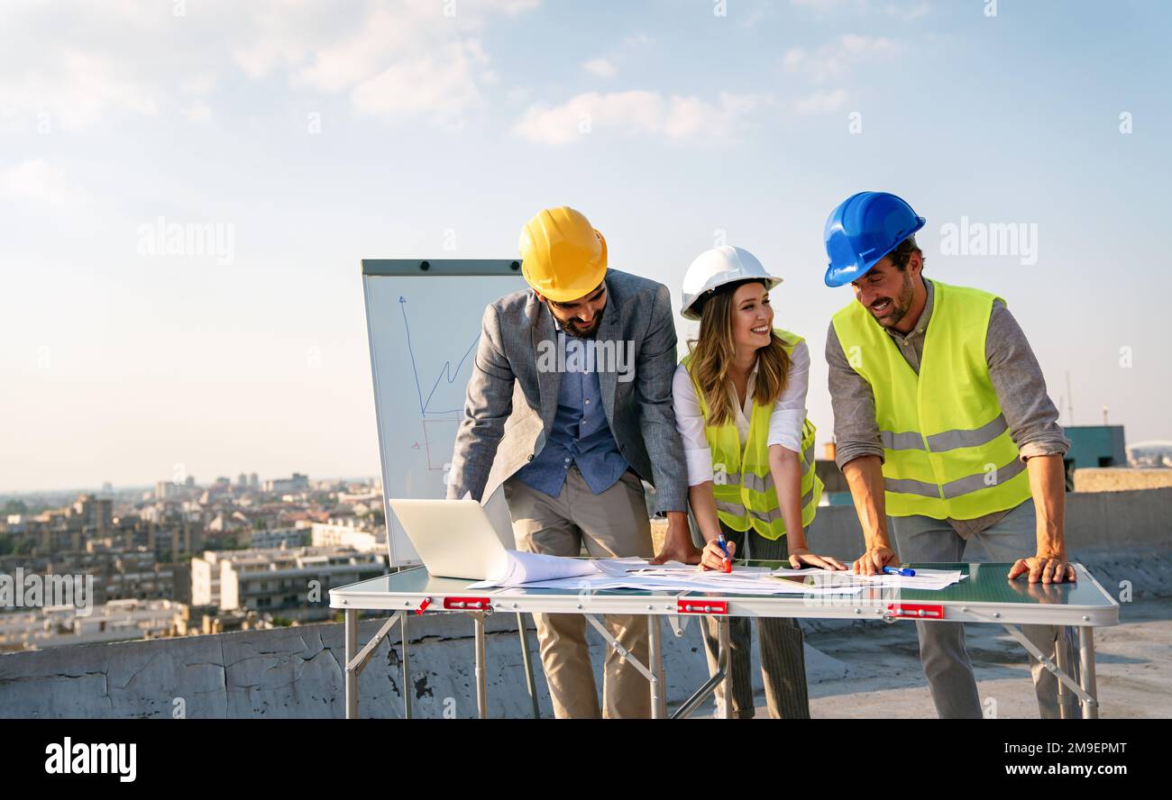 Construction concept. Engineers and architects working at construction ...