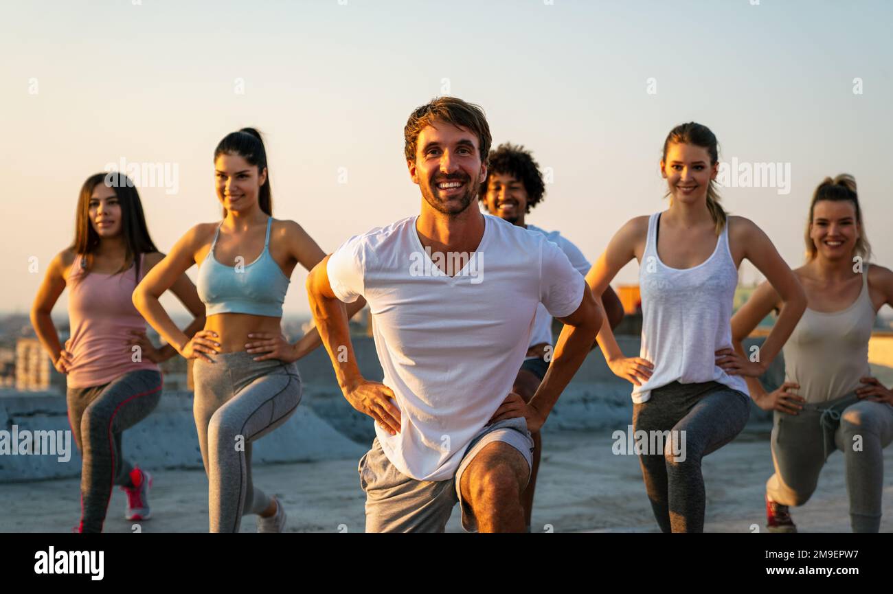 Group of happy fit people friends exercising together outdoor to stay ...