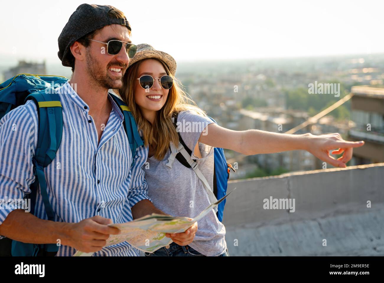 Happy couple on vacation sightseeing city with map. People travel fun ...