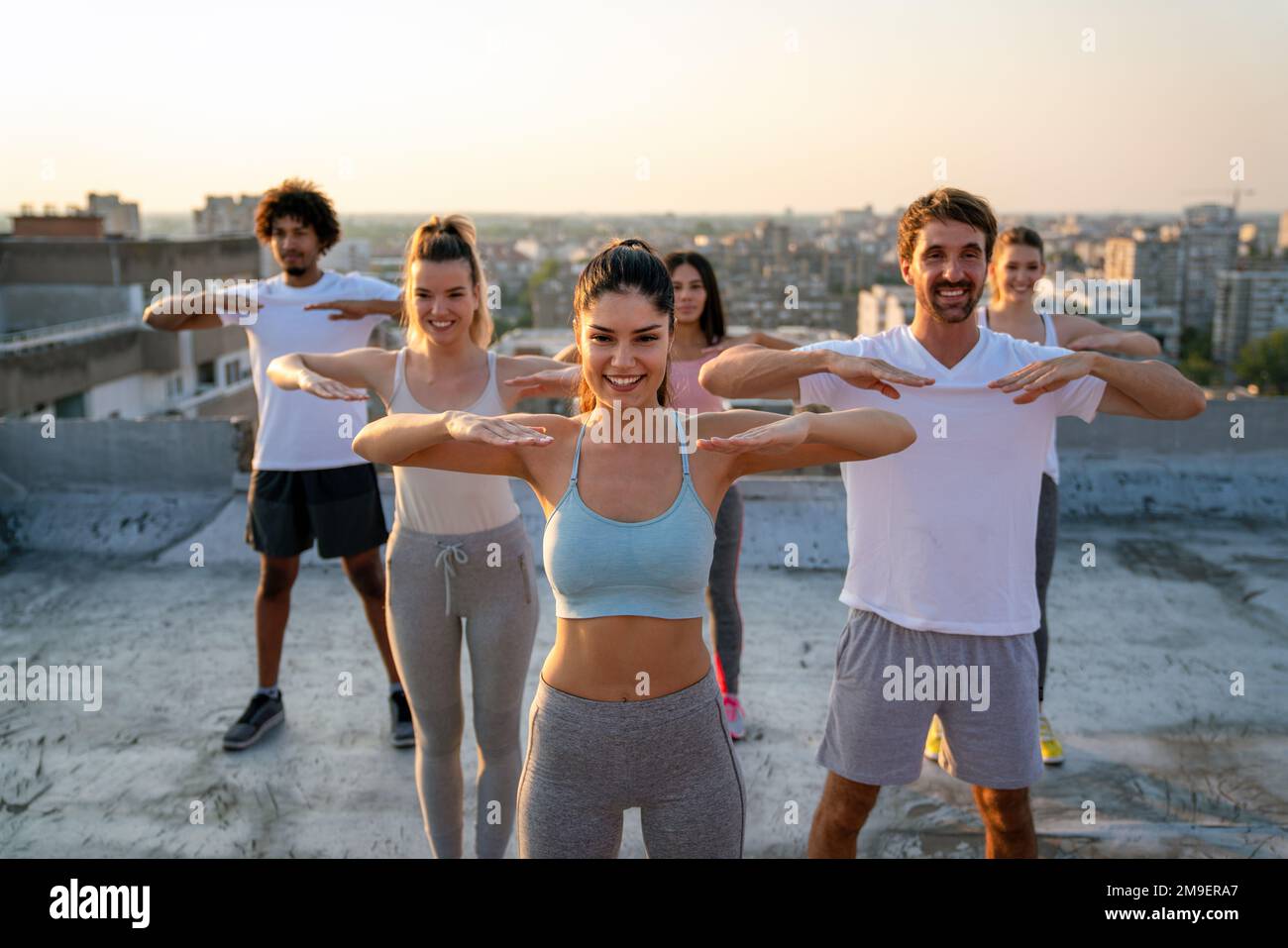 Group of fit healthy friends, people exercising together outdoor Stock ...