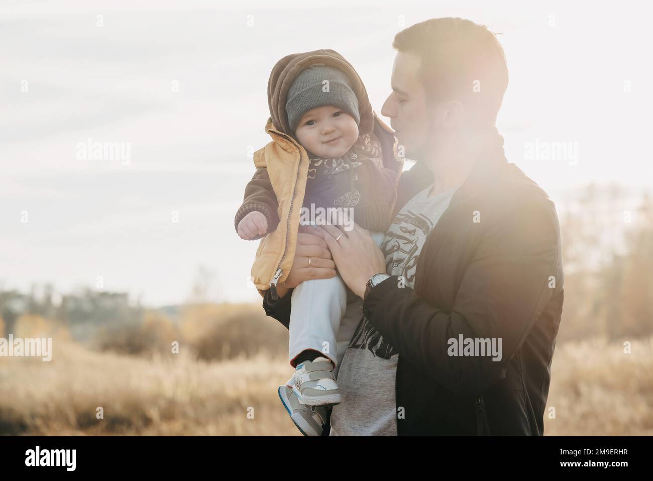 dad holding a small child son of a boy in the fall in nature Stock ...