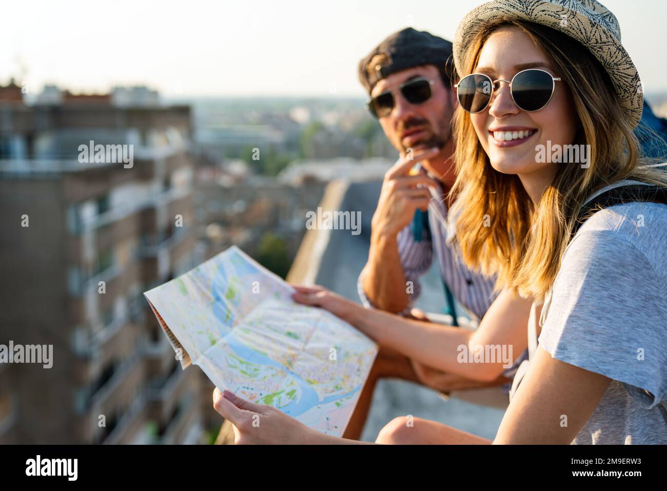 Happy couple on vacation sightseeing city with map. People travel fun ...