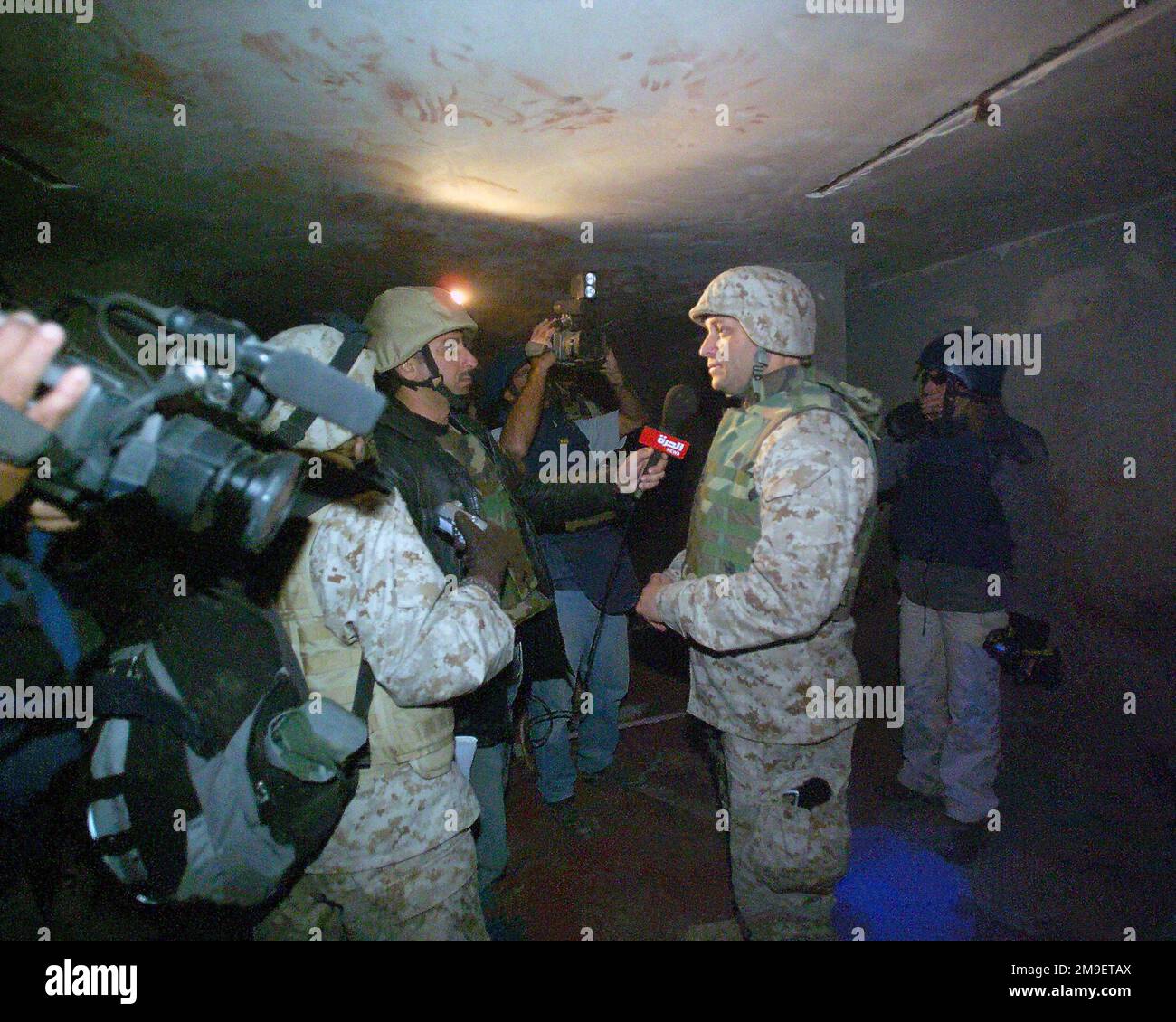 041202-M-2583M-028. [Complete] Scene Caption: An Arab news reporter ...