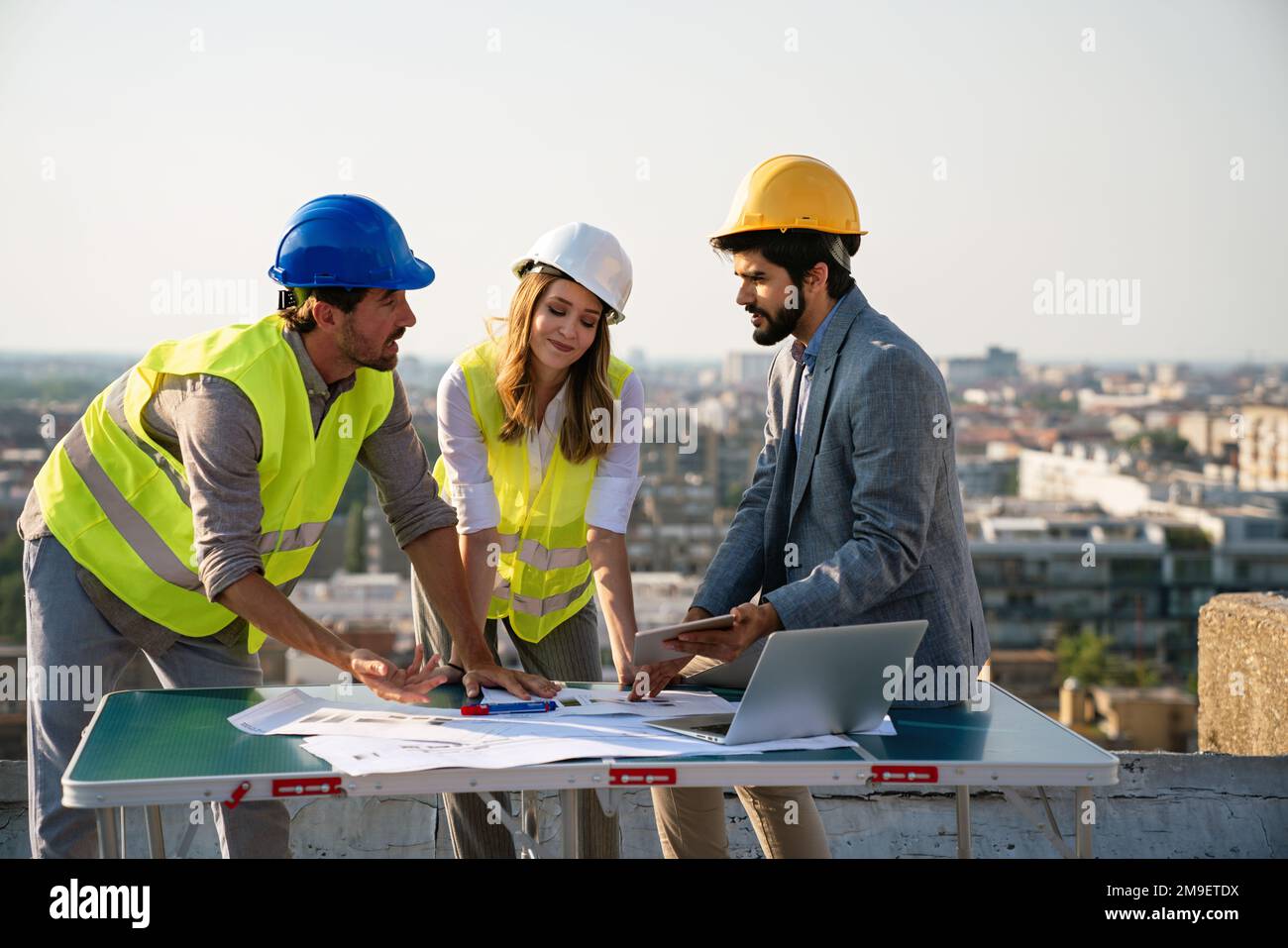 Group of engineers, architects, business partners at construction site ...