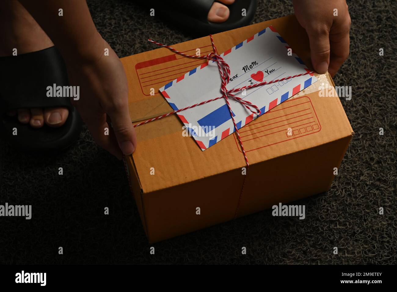 Man receiving deliver parcels box with greeting card on the door mat ...