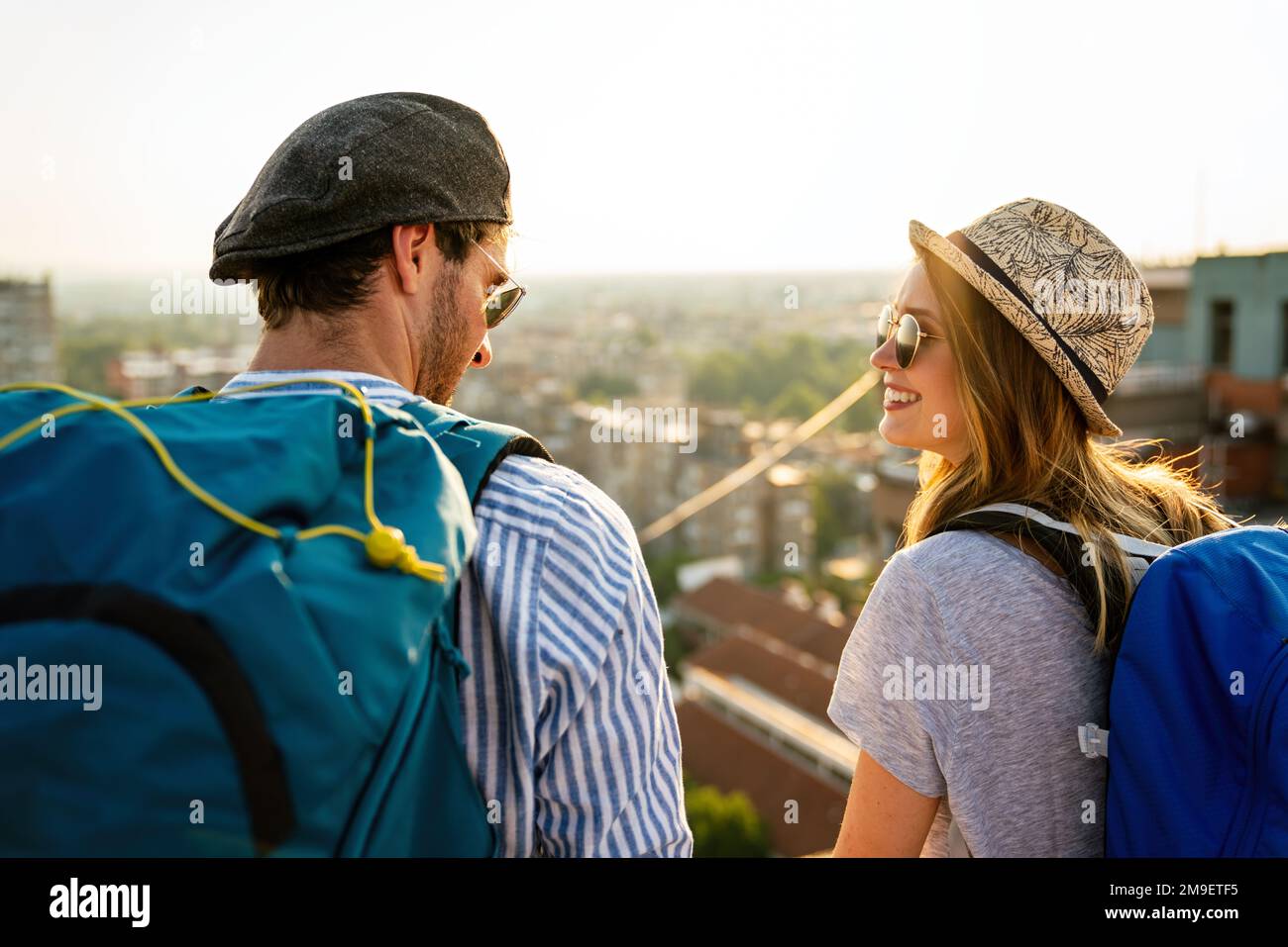 Happy tourists couple, friends sightseeing city with map together ...