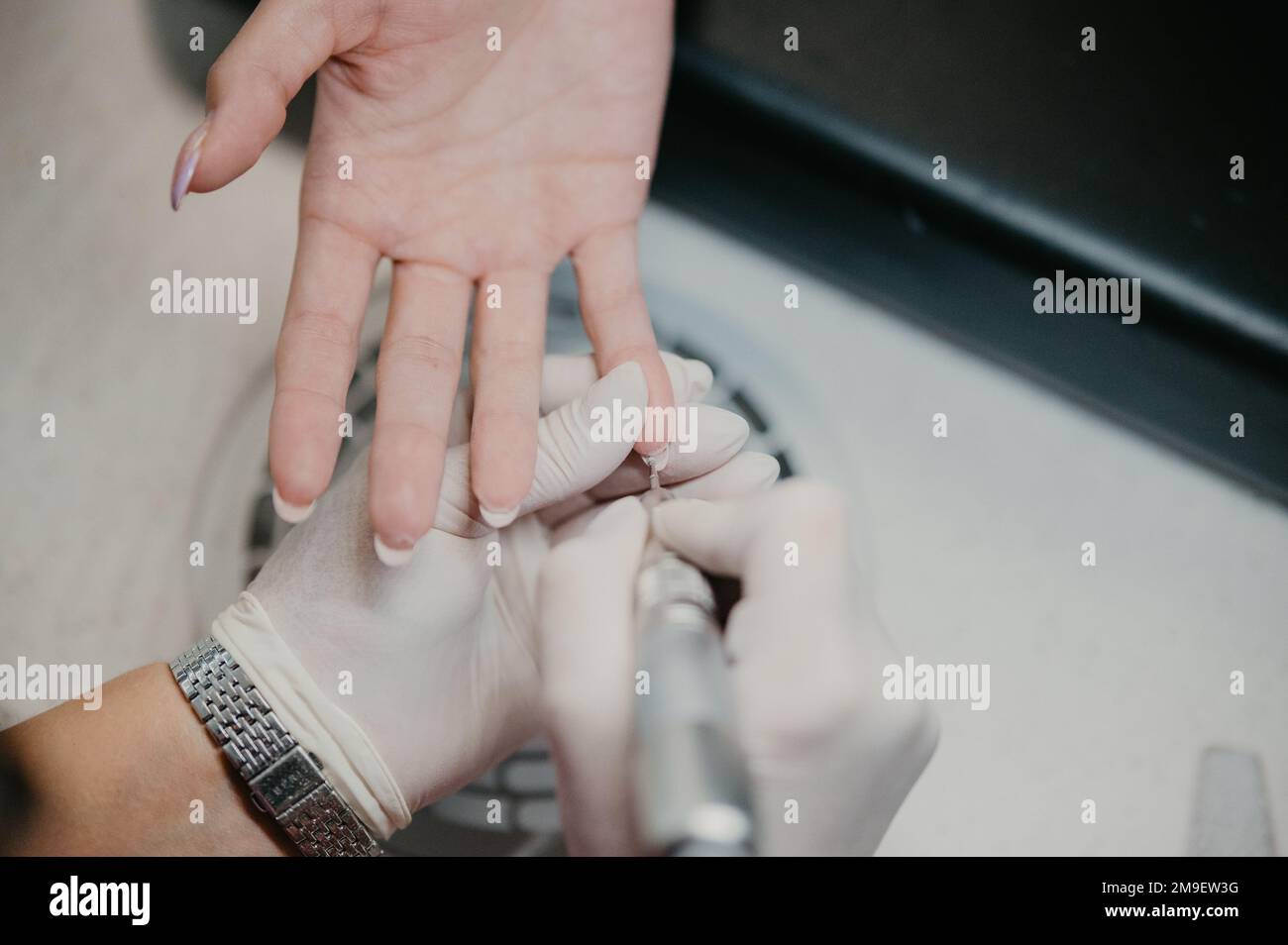 A closeup shot of the nail master working on the client's nails Stock ...