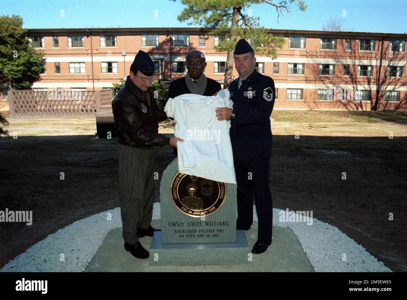 Medium shot, front view, a bronze and granite marker dedicating the new ...