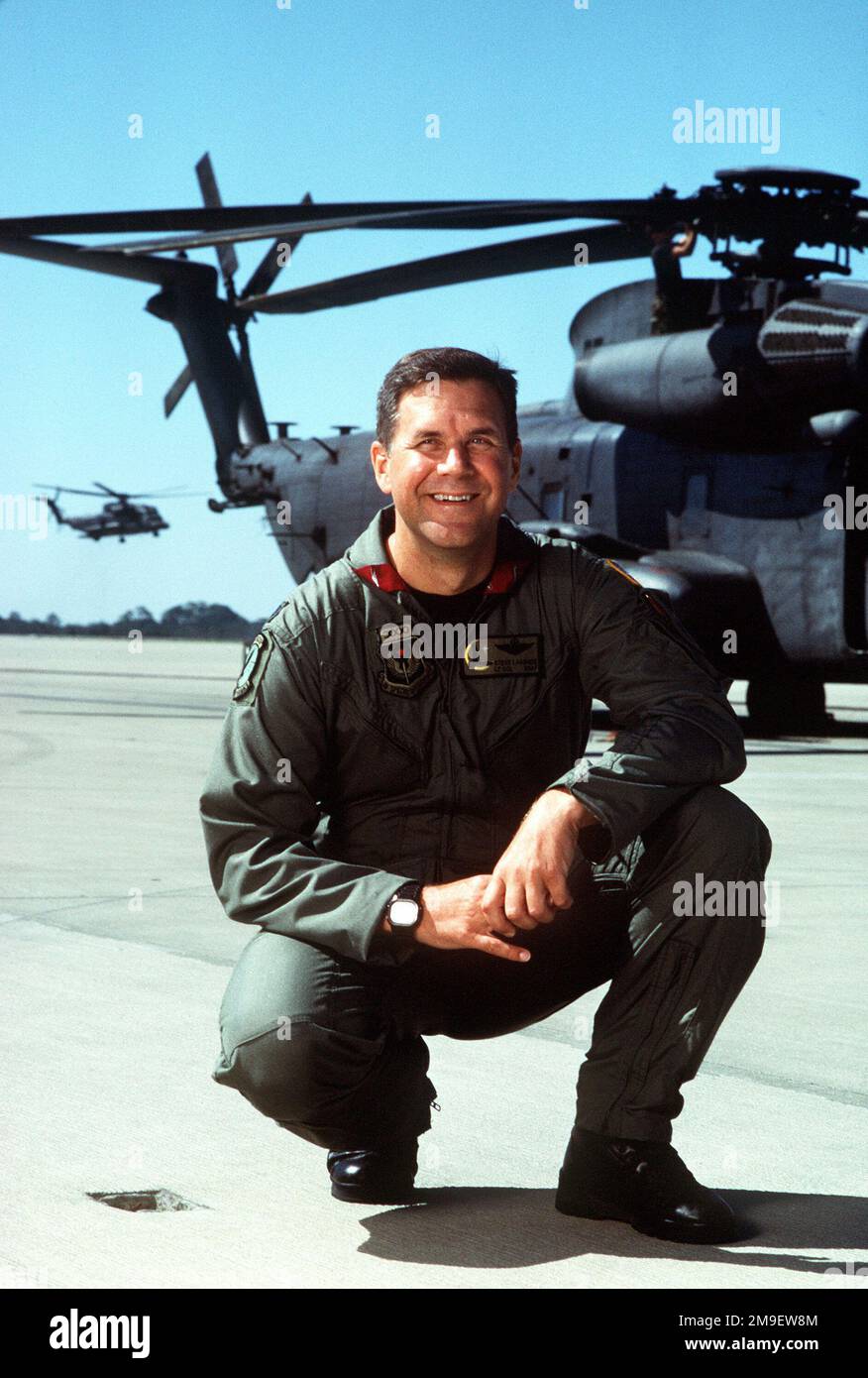 US Air Force Lieutenant Colonel Steve Laushine, in front of an MH-53J ...