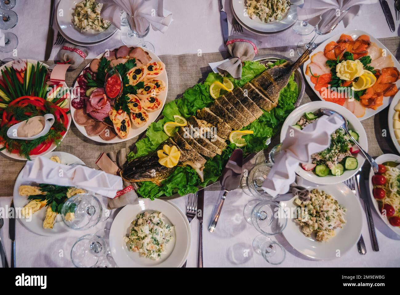 traditional Russian cuisine with baked stuffed pike and other snacks on ...