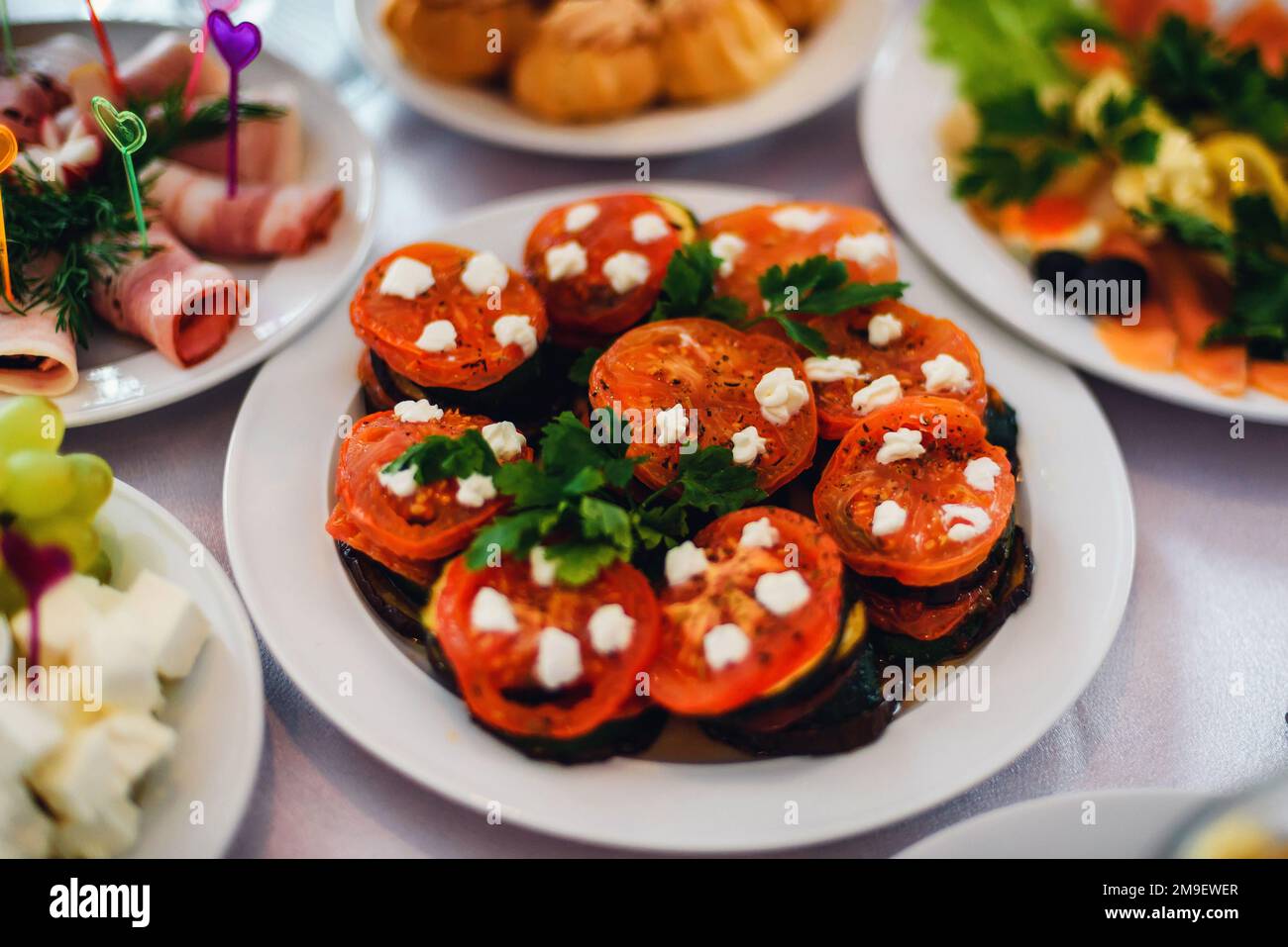 tomato and eggplant appetizer on the table for dinner in the restaurant ...