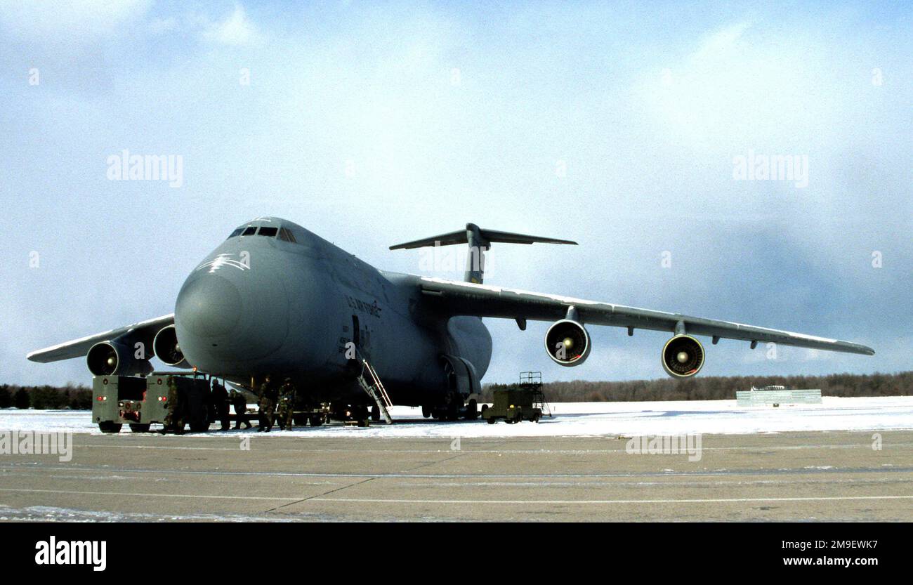 Lung shot. C-5 Galaxy Aircraft parked on the flightline in snow at ...
