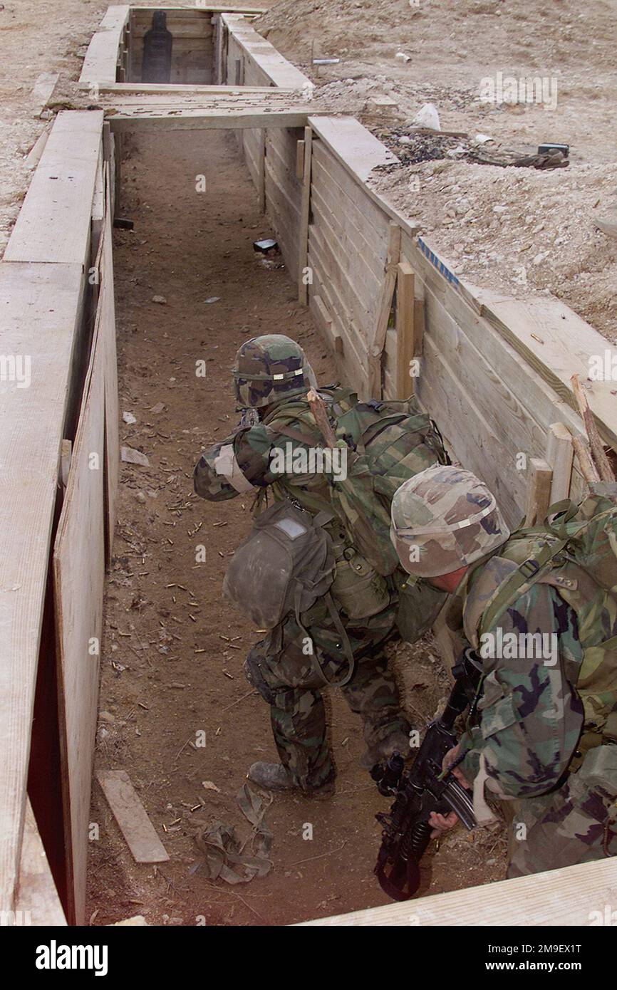 A US Army Pointman fires his fires at targets as SOldiers from 1ST ...