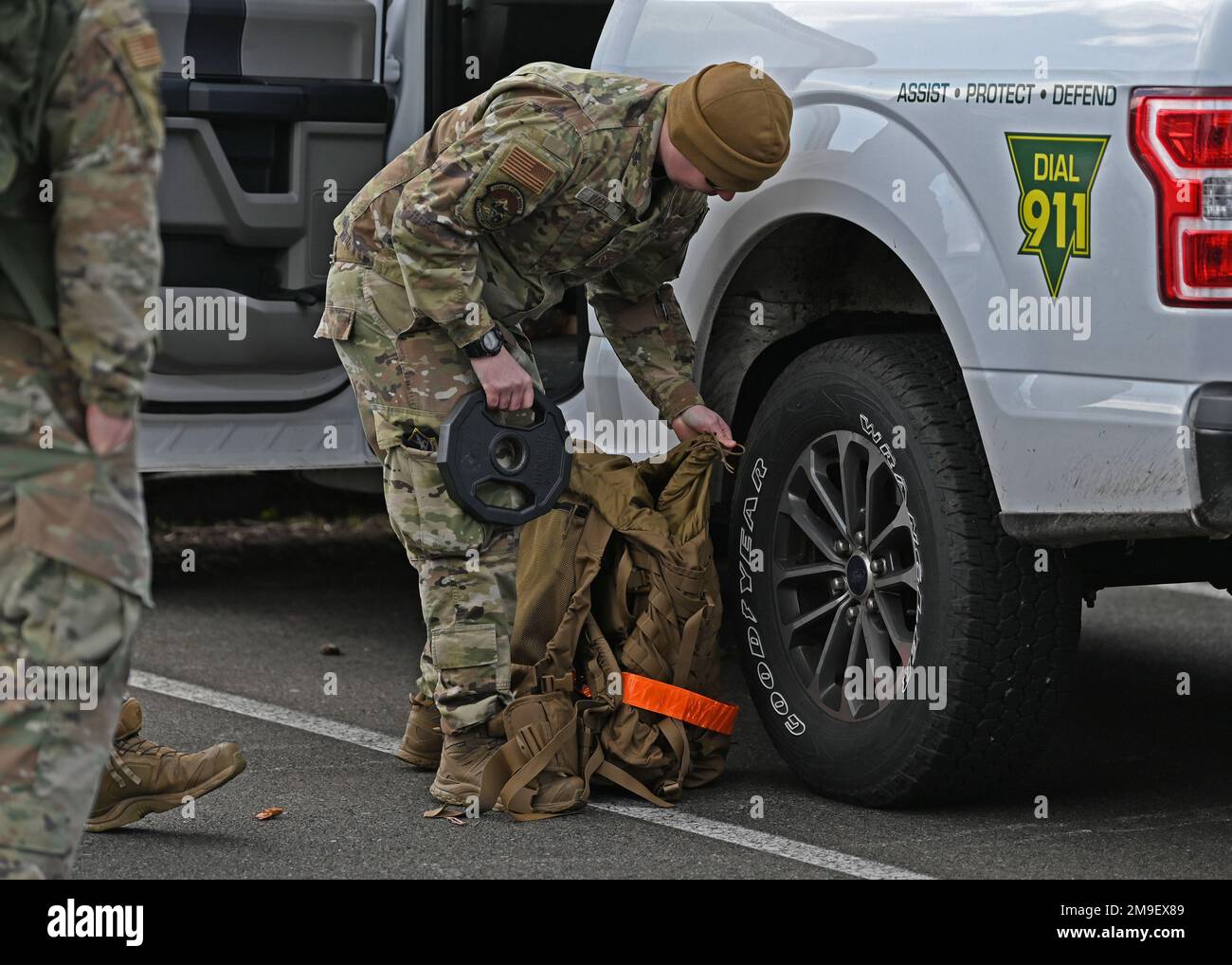 A U.S. Airman with the 627th Security Forces Squadron loads weights into his pack before ...