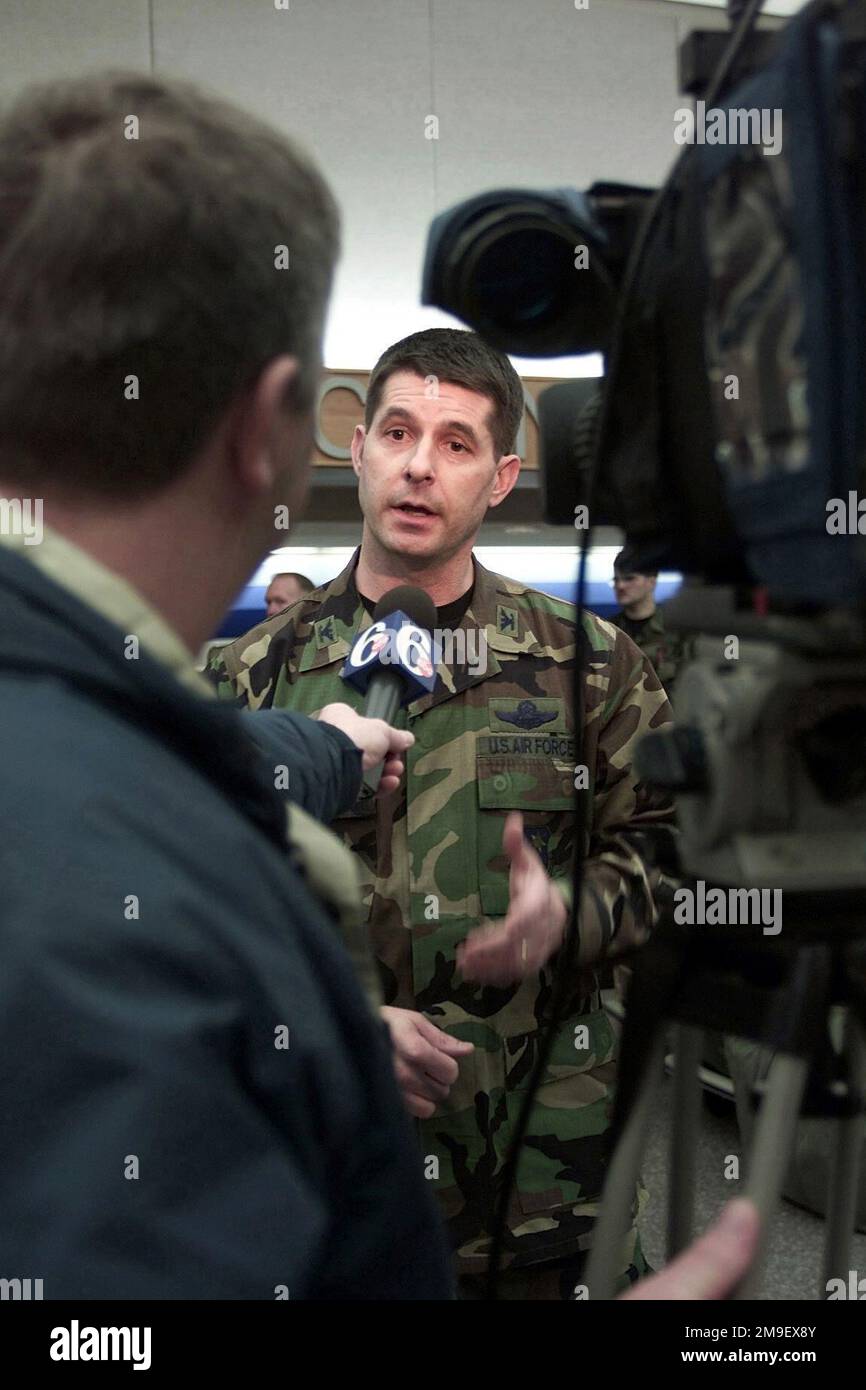 Straight on medium shot over the right shoulder of a television news ...