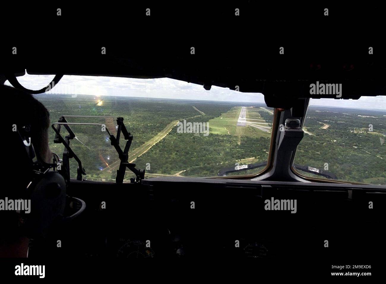 An interior shot over the right shoulder and out the front window as ...