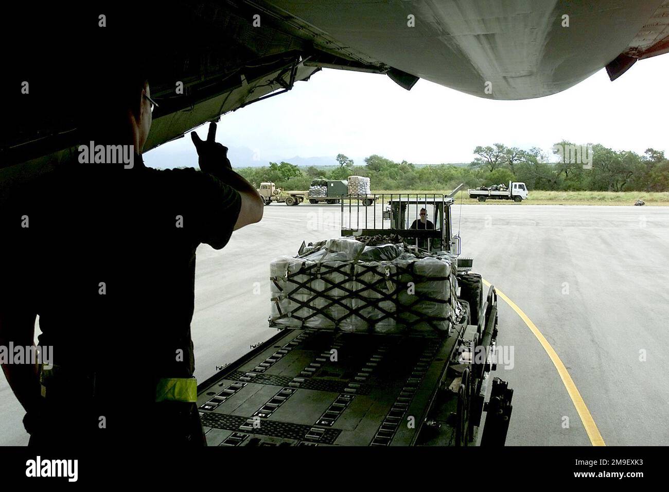 Palletized relief supplies for "Operation Atlas Response" are unloaded ...