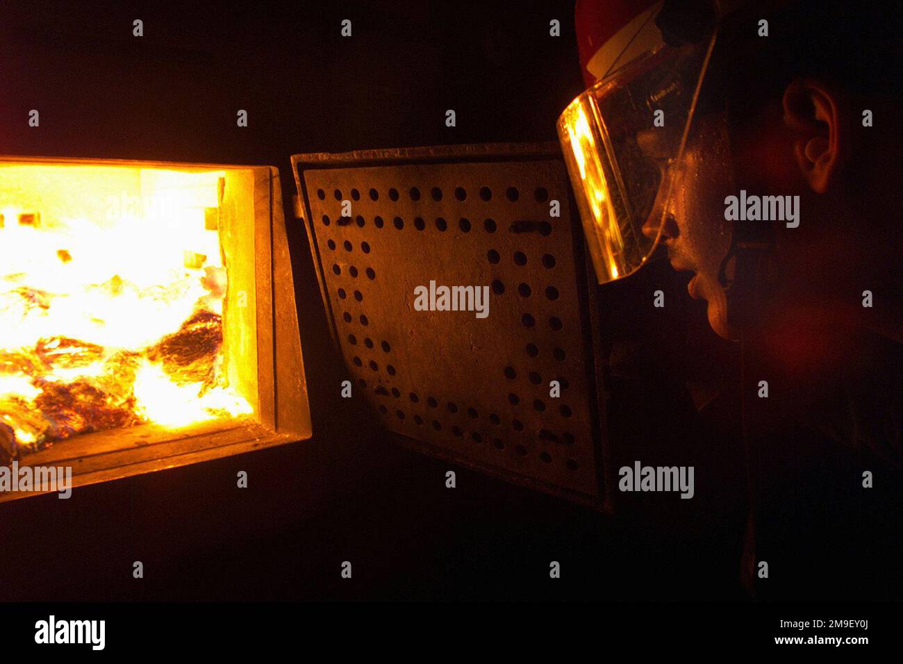 Roy Vlasuk stokes the fire to prevent damage to the incinerator from ...