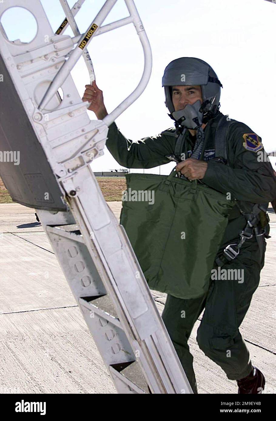 Medium shot. Mr. McKee prepares to climb into a B-1 for his flight ...