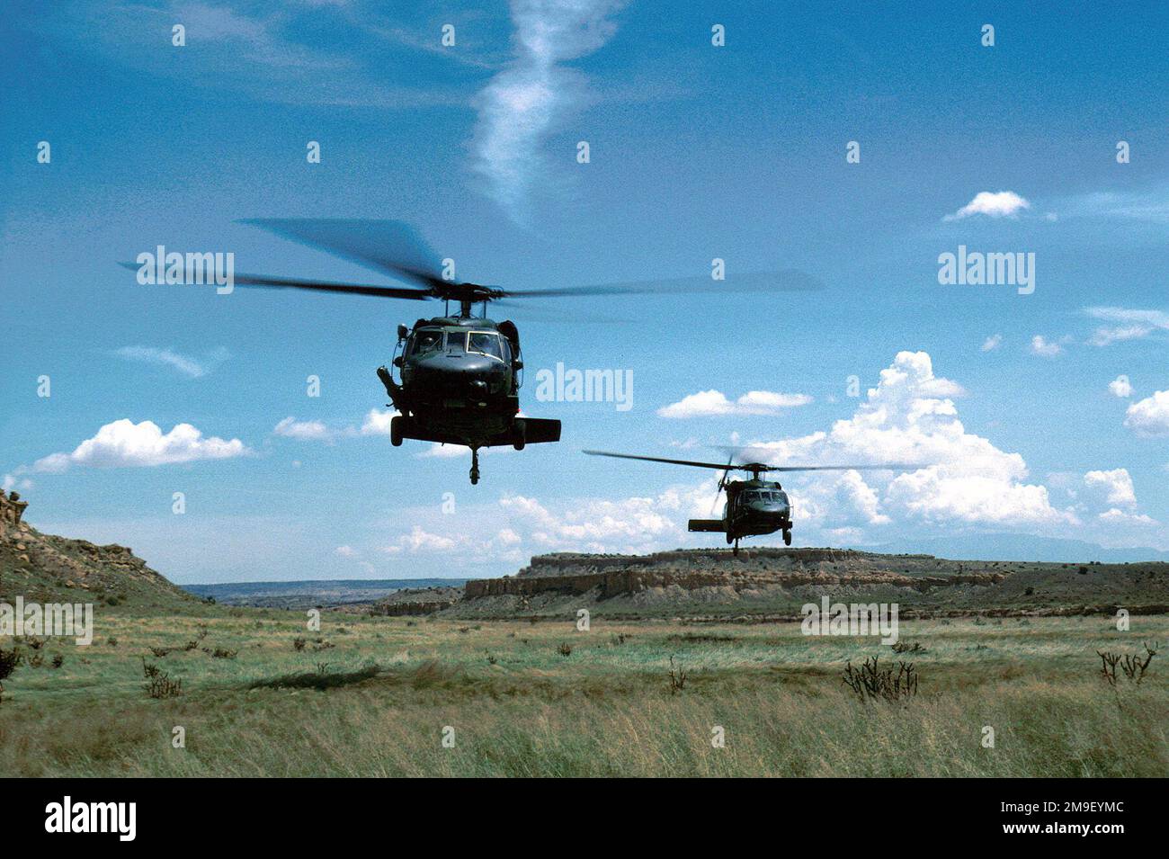 Medium long shot, front view, low angle, two HH-60G Blackhawks in ...