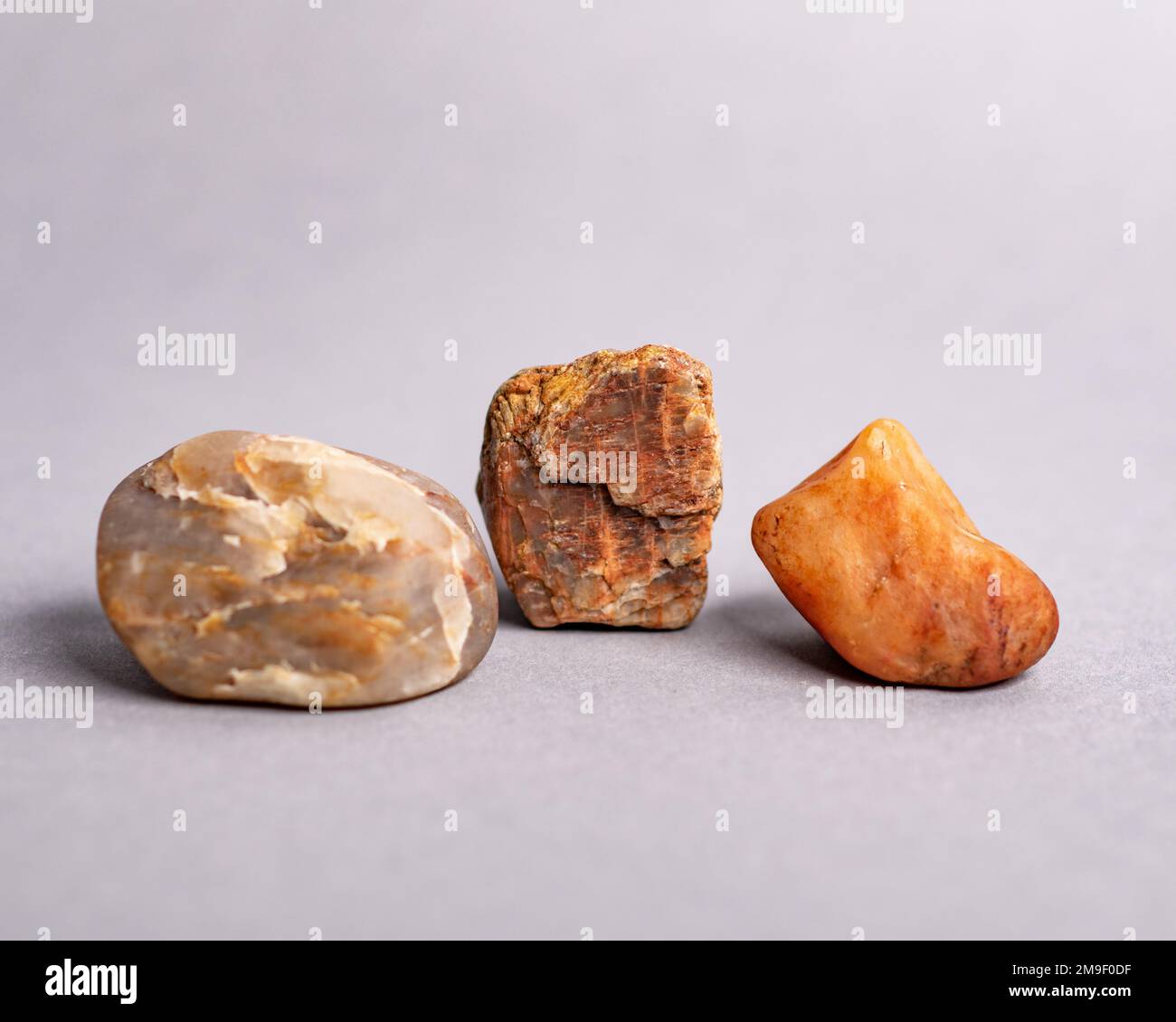 A close-up of the natural stones placed by each other, on a light ...