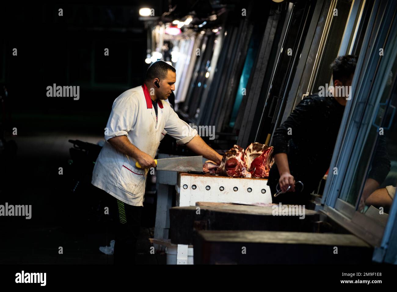A man chopping meat in a market hall in Athens, Greece Stock Photo - Alamy