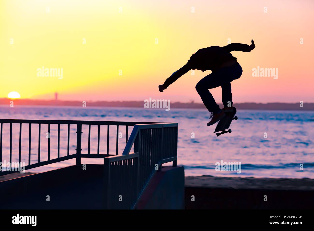 Unrecognizable teenage boy silhouette showing high jump tricks on ...