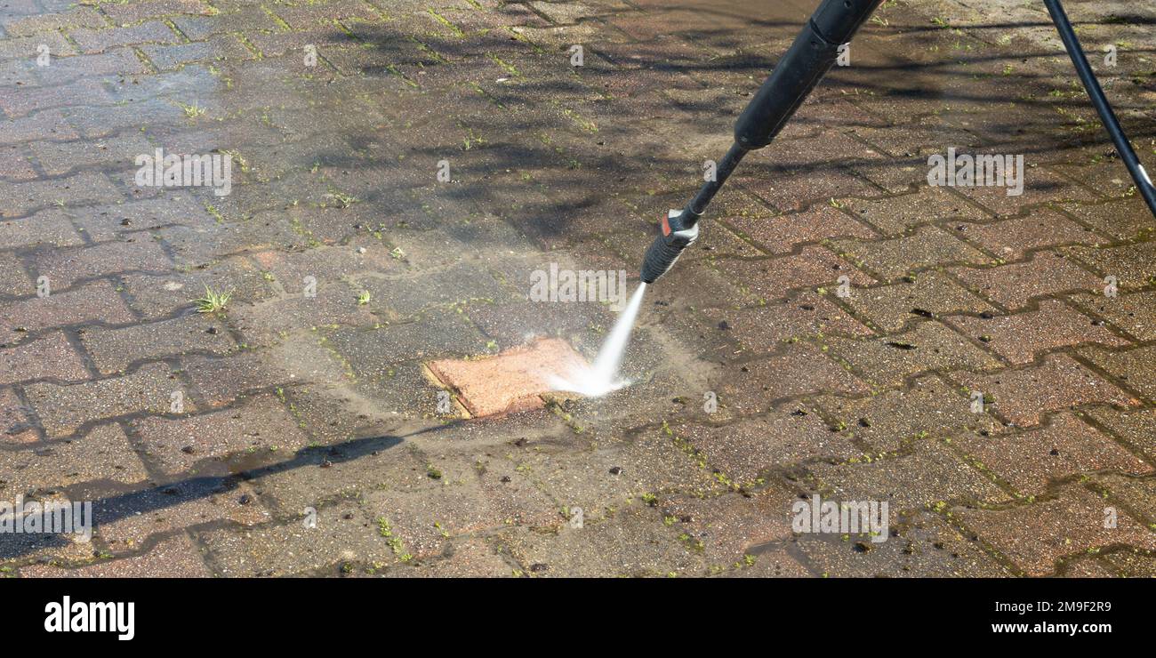 Outdoor floor Worker cleaning driveway with a pressure water jet Stock ...