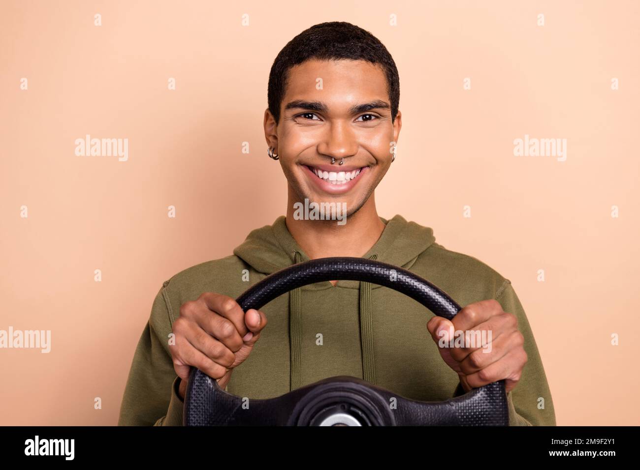 Photo of cheerful man wear khaki sweatshirt have first drive test good ...