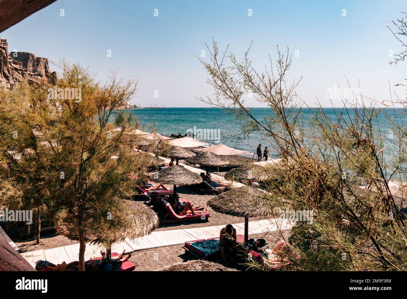 View over the beach area of Theros Wave Bar on Eros beach in Santorini ...