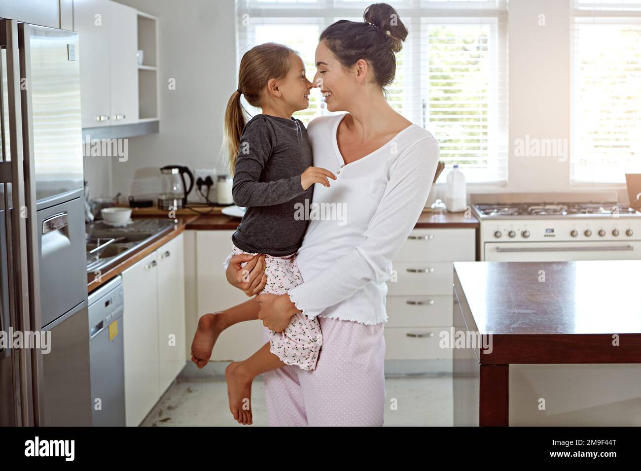 Home, kitchen and mother hug child for bonding, love or holiday ...