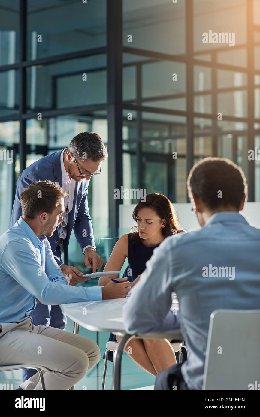 Man, tablet and business people in meeting for coaching, goals and ...