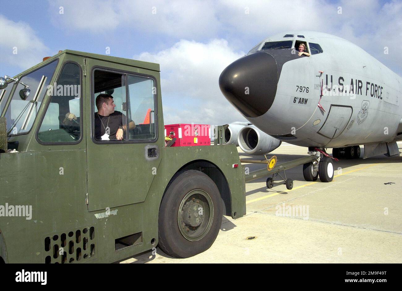 Left side profile medium shot of a US Air Force aircraft towing vehicle ...