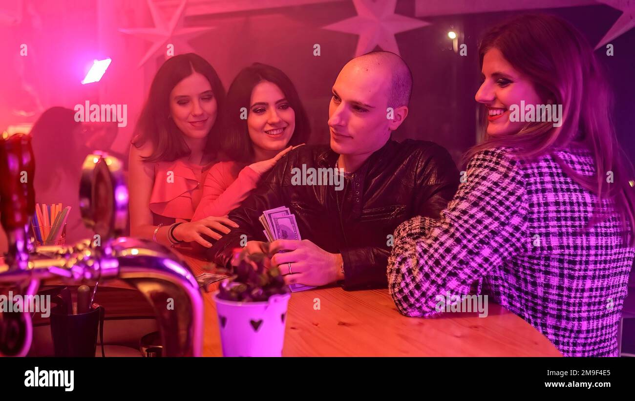 Man surrounded women nightlife hi-res stock photography and images - Alamy