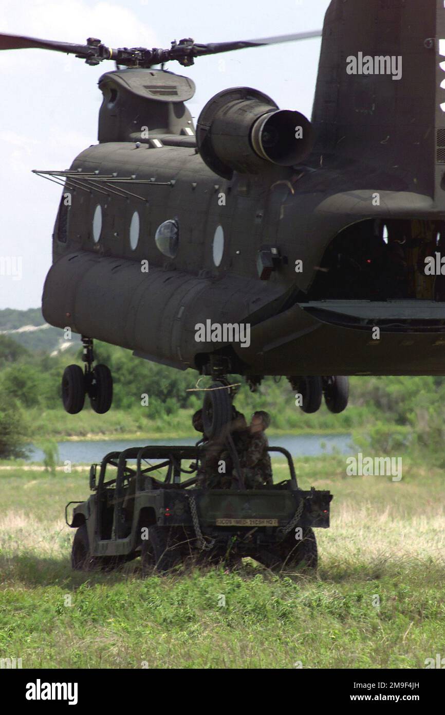 A High-Mobility Multipurpose Wheeled Vehicle (HMMWV) is attached to the center-bay hoist of a ...