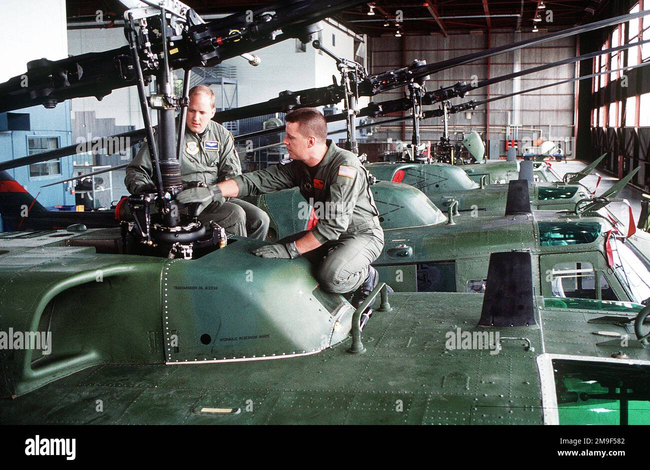 US Air Force STAFF Sergeant Brian West (right), a flight engineer ...