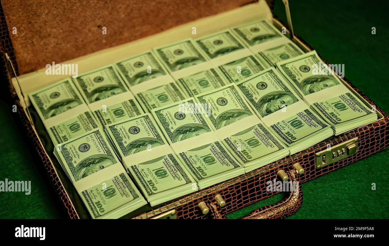 A man is seen unlocking a briefcase in a dimly lit nightclub. As he ...