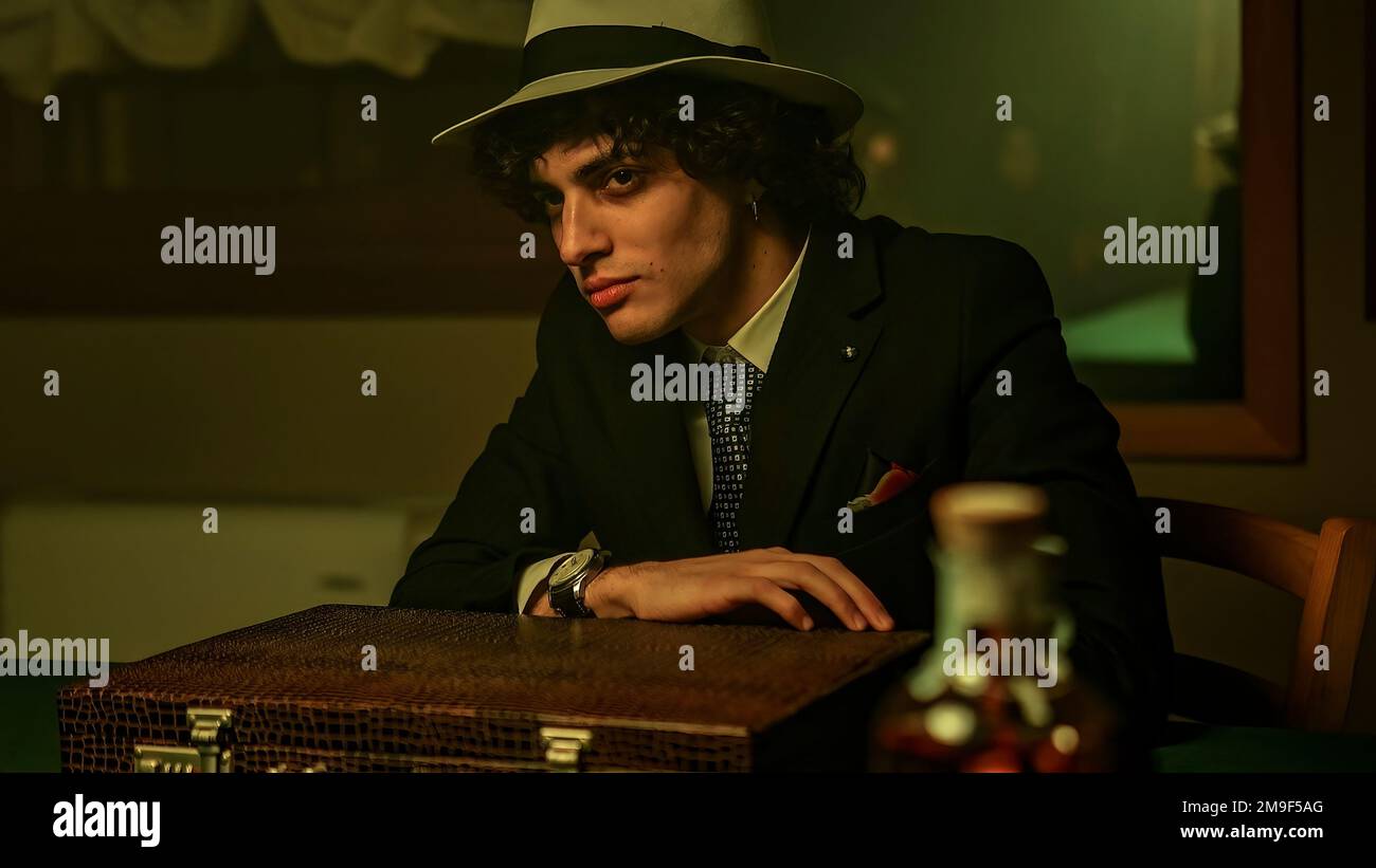 Two mobsters in a dimly lit room filled with smoke. They are engaged in ...