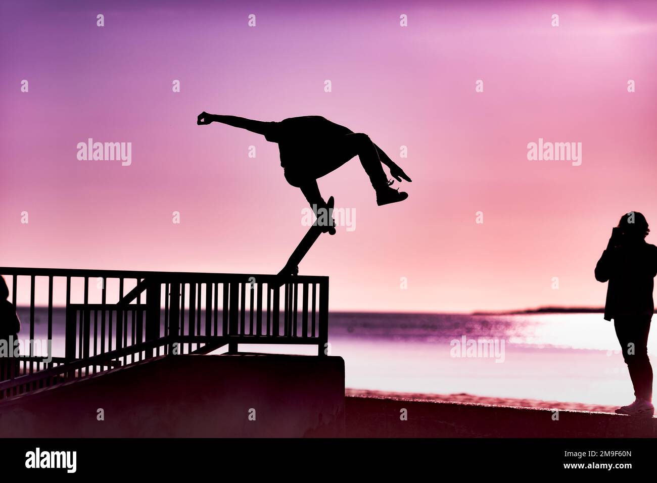 Unrecognizable teenage boy silhouette showing high jump tricks on ...