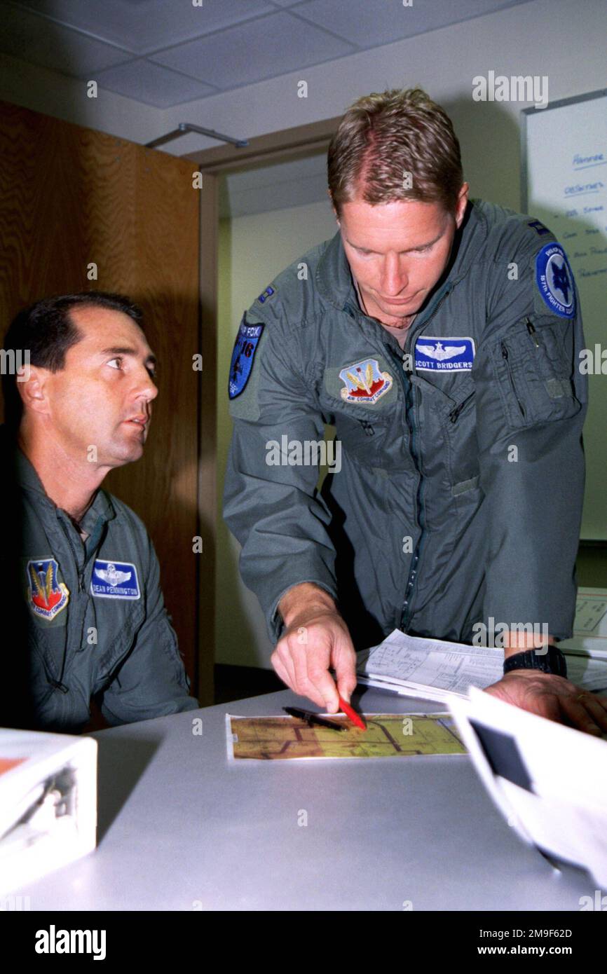 Captain Scott Bridgers conducts a preflight briefing with Lieutenant ...