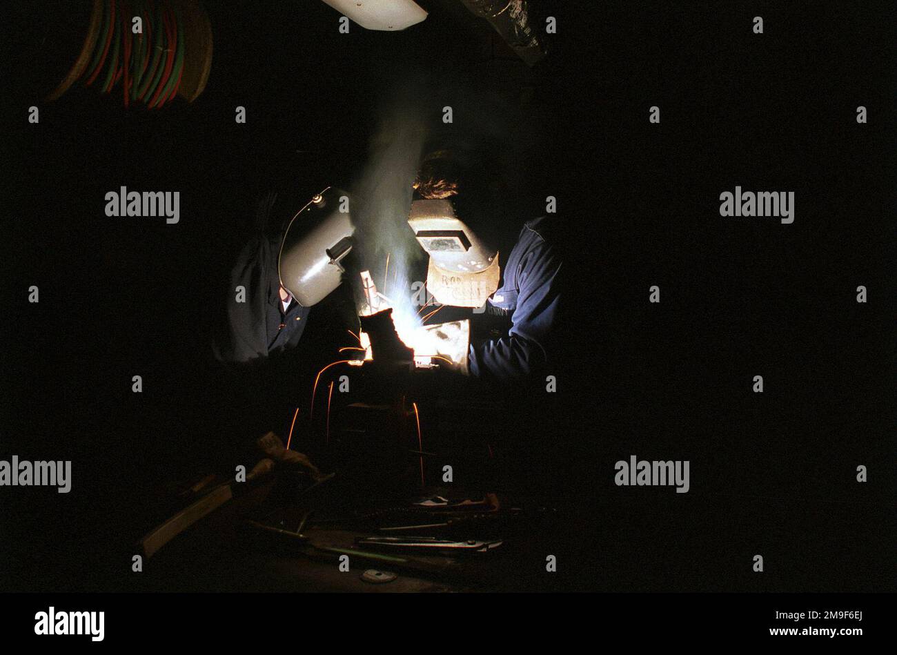 Hull Techicians weld a piece of equipment in the pipe shop on board USS ...