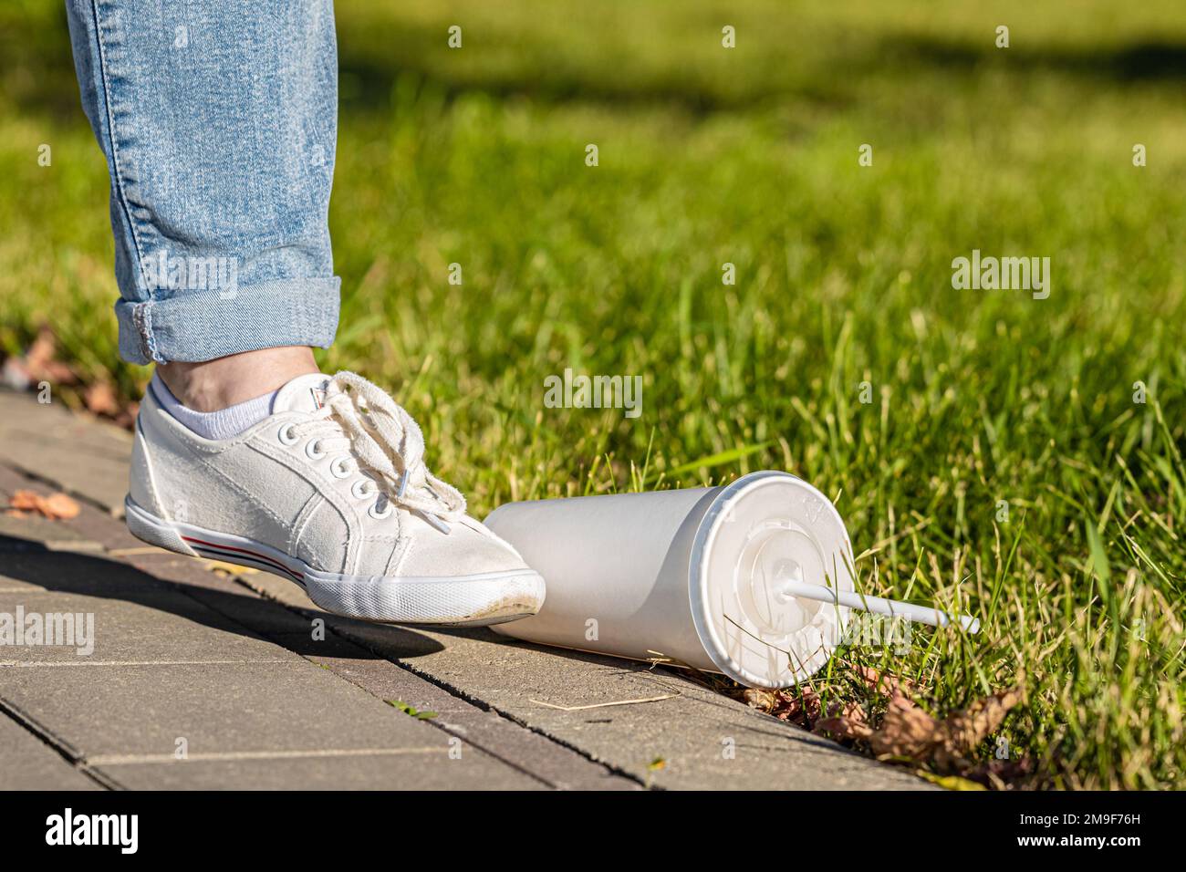 man throws garbage on the street lawn. man throws garbage in the wrong ...